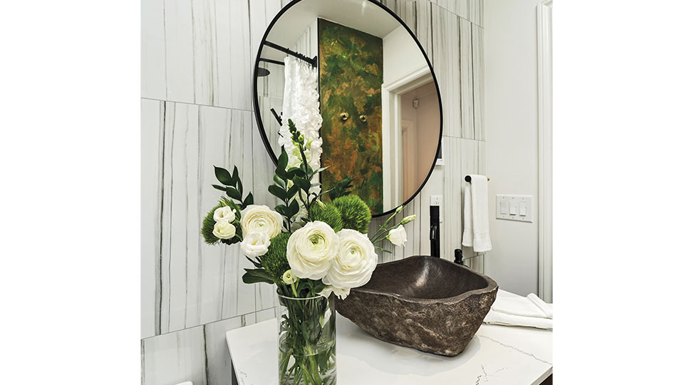 A cool carved river stone sink gives this bathroom reno a special “wow ...